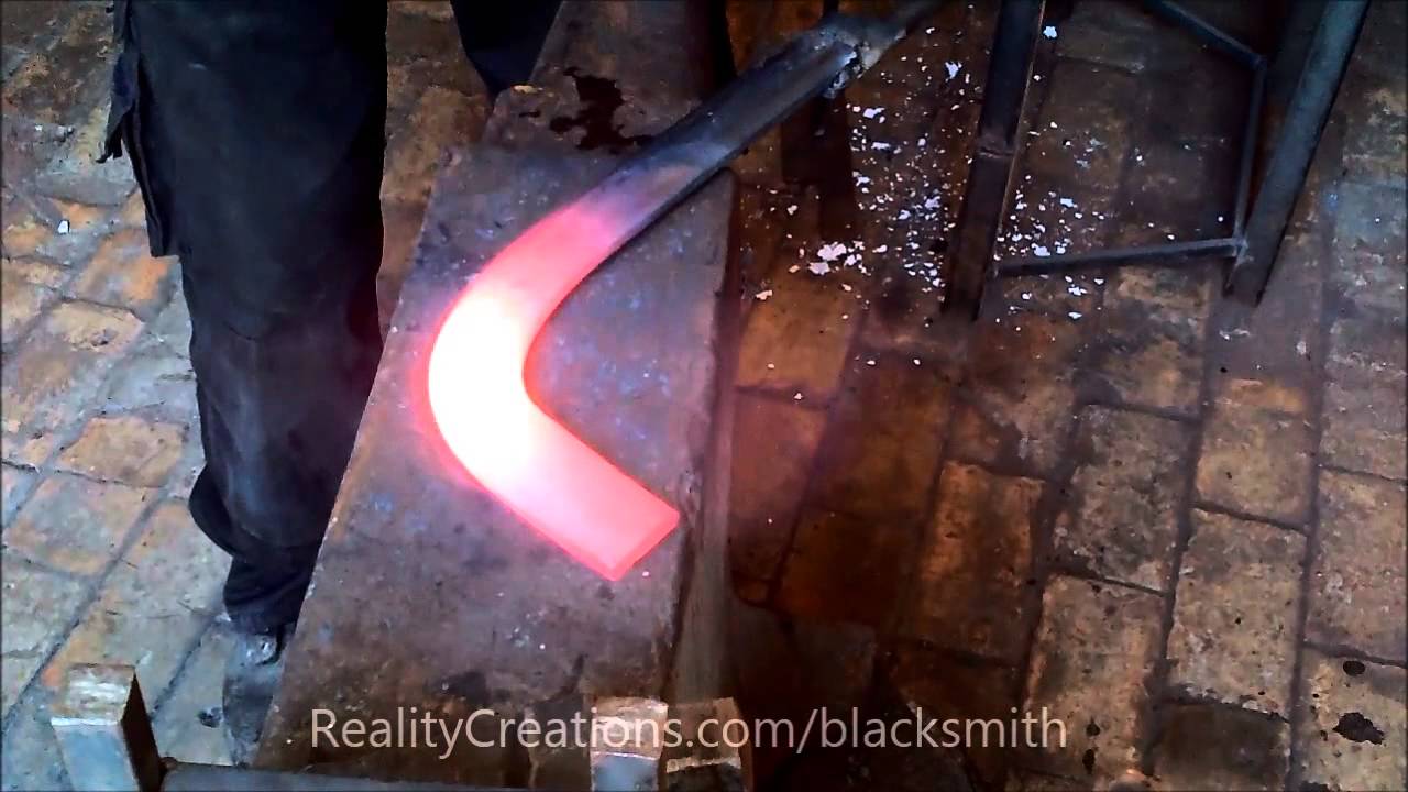 Making a right angle bend in hot iron convex bar from forge - YouTube