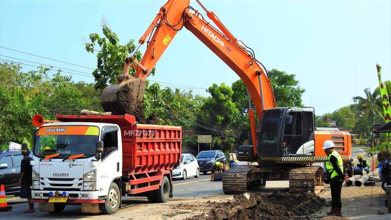 Excavator Trucks Working On The Road Reinforcement Construction - YouTube