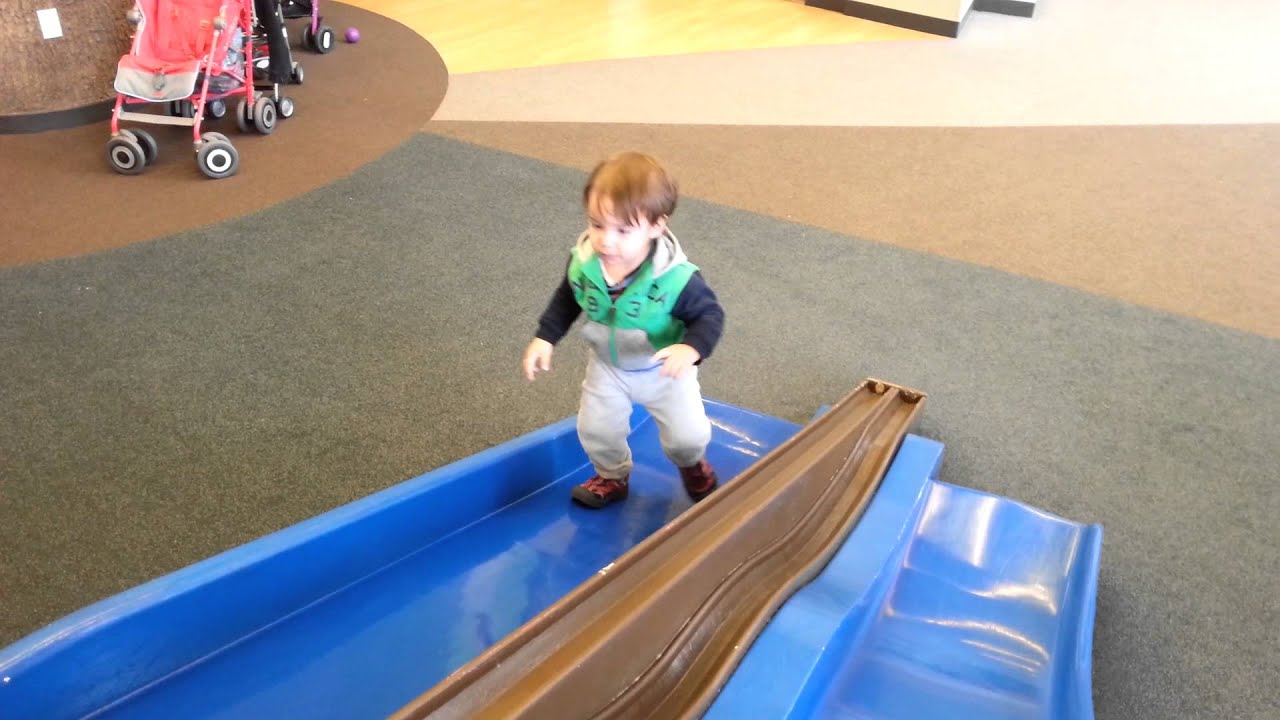 Juju going down slide at COSI and coming back up the wrong way - YouTube