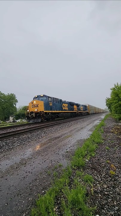Norfolk Southern 264 passes as CSX train approaches with new CM44AH locomotives pulling long ...