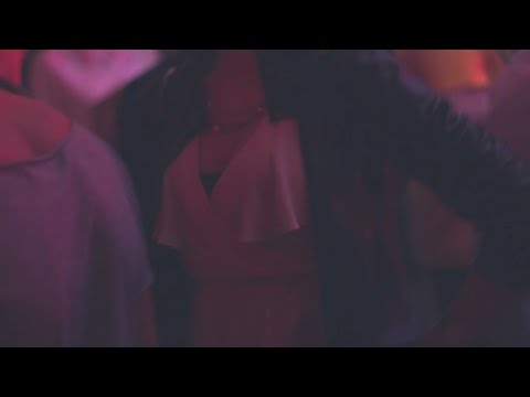 Discotheque girl with open decollete dress dances in night club at party. Stock Footage