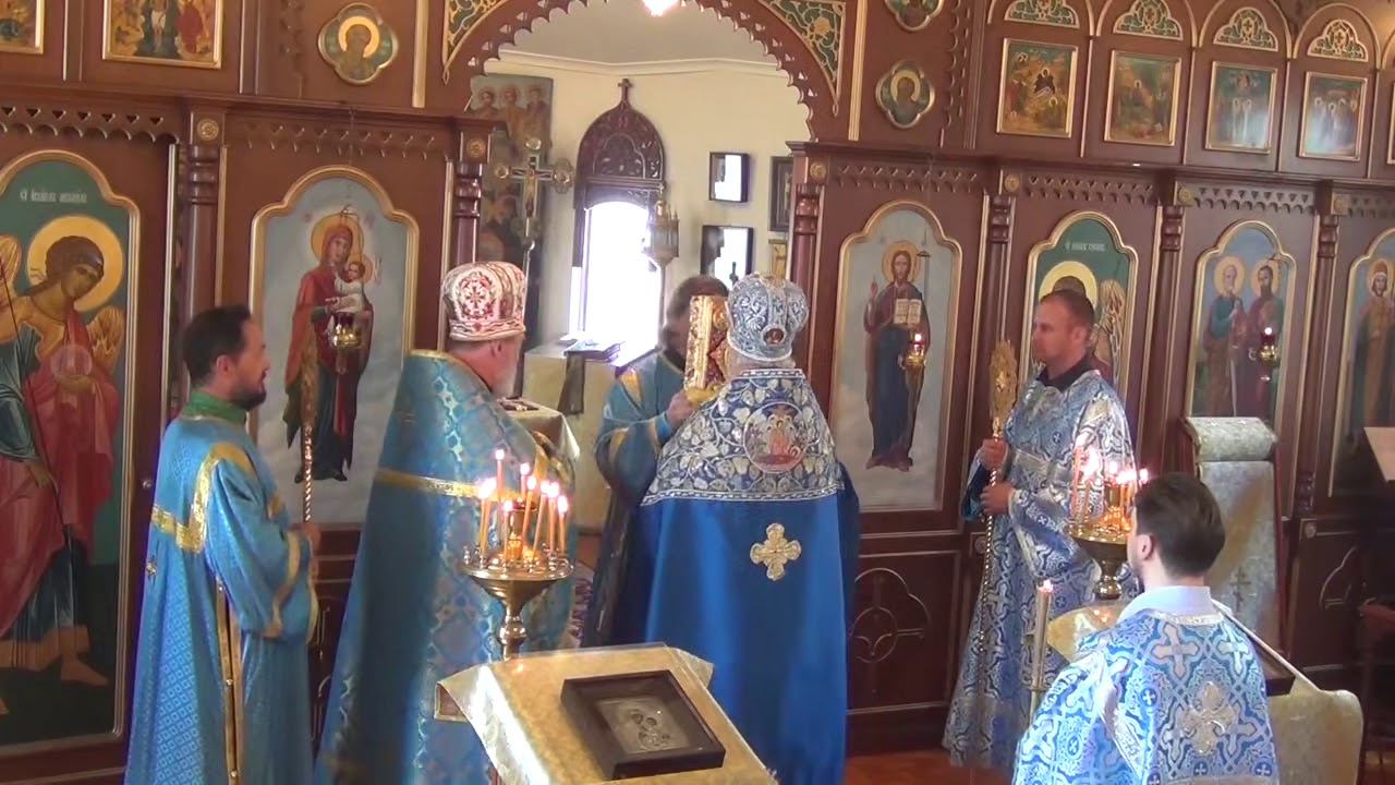 Fr Sergei Okunev is presented with a mitre by Fr Michael Protopopov ...