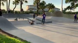 Skateboarder board slides rail at skatepark and lands in scorpion ...