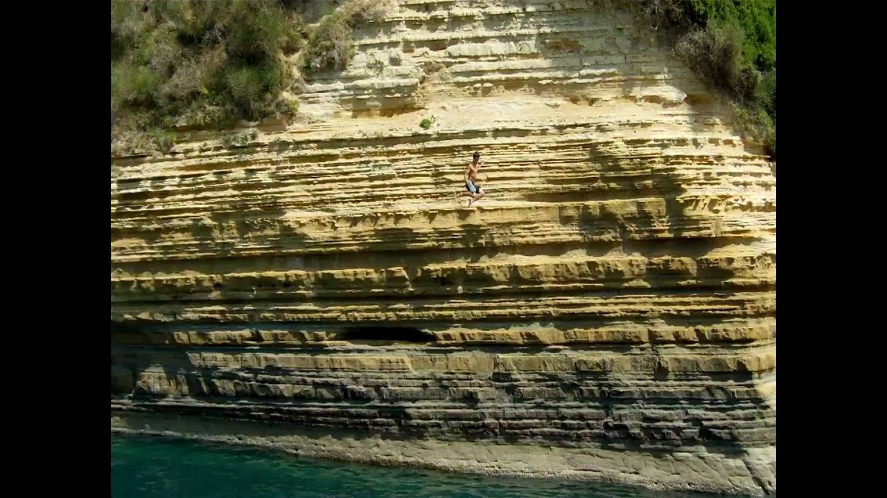 Crazy guy jumping off a cliff in Corfu Greece - YouTube