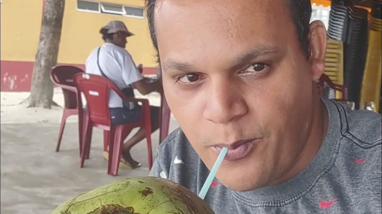 Tomando água de coco no quiosque na praia grande em Ubatuba SP, praia ...