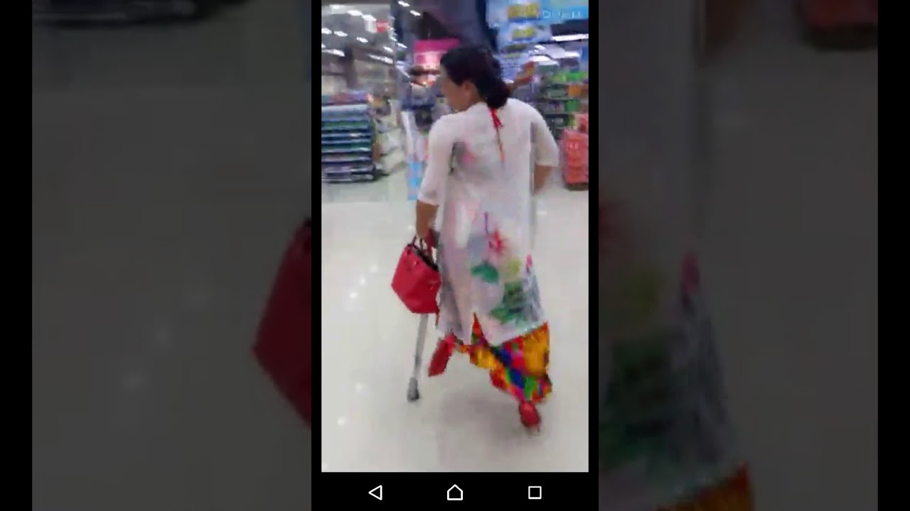 Polio woman with colorful dress in the souvenir shop - YouTube