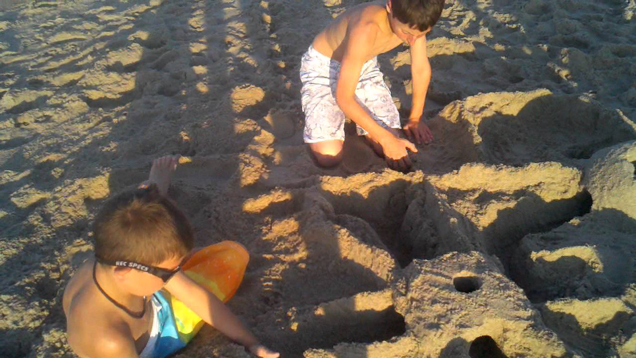 Boys building a sand castle - YouTube