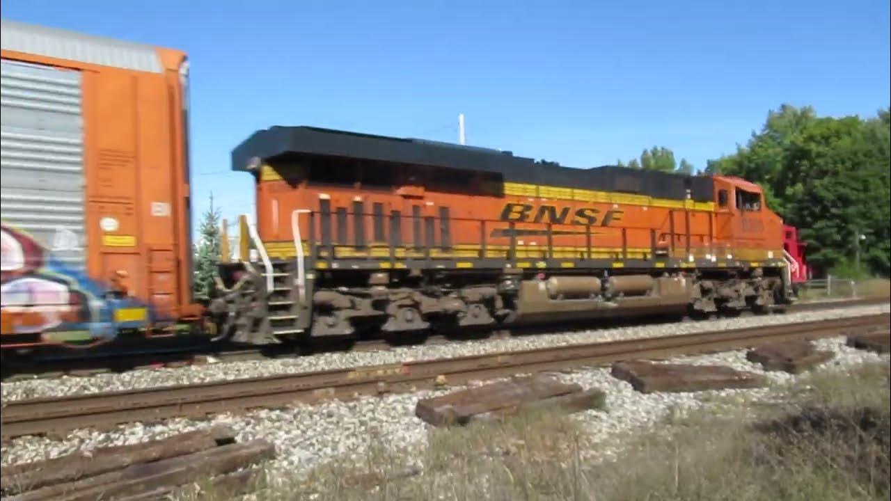 BNSF 8360 runs an auto carrier train East, CN 2867, UP 6555 moves freight cars West at Vicksburg ...