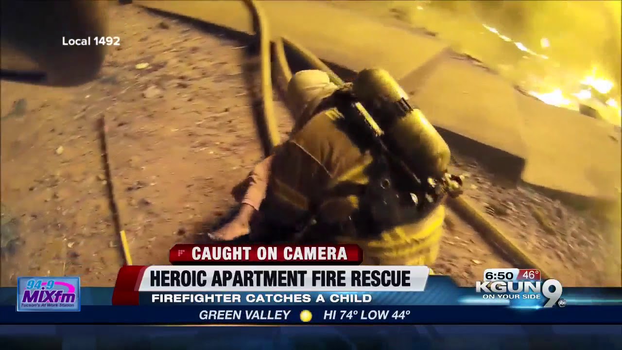 Firefighter catches child escaping from apartment fire - YouTube