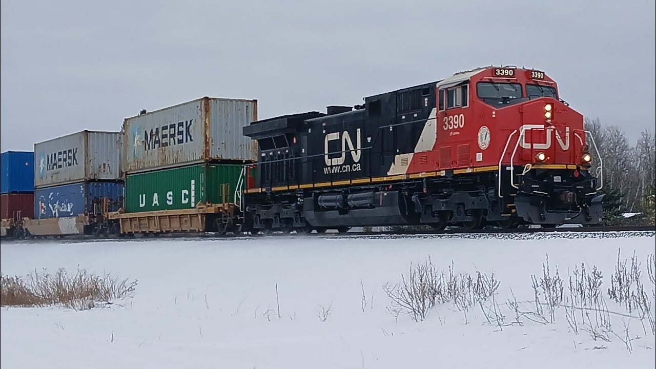 VERY LONG CN train with a red box car and a DPU in Oliver wi with ...