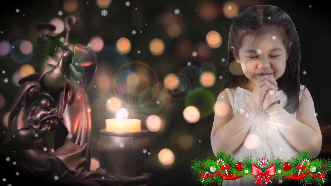 Child praying with the christmas candle - YouTube