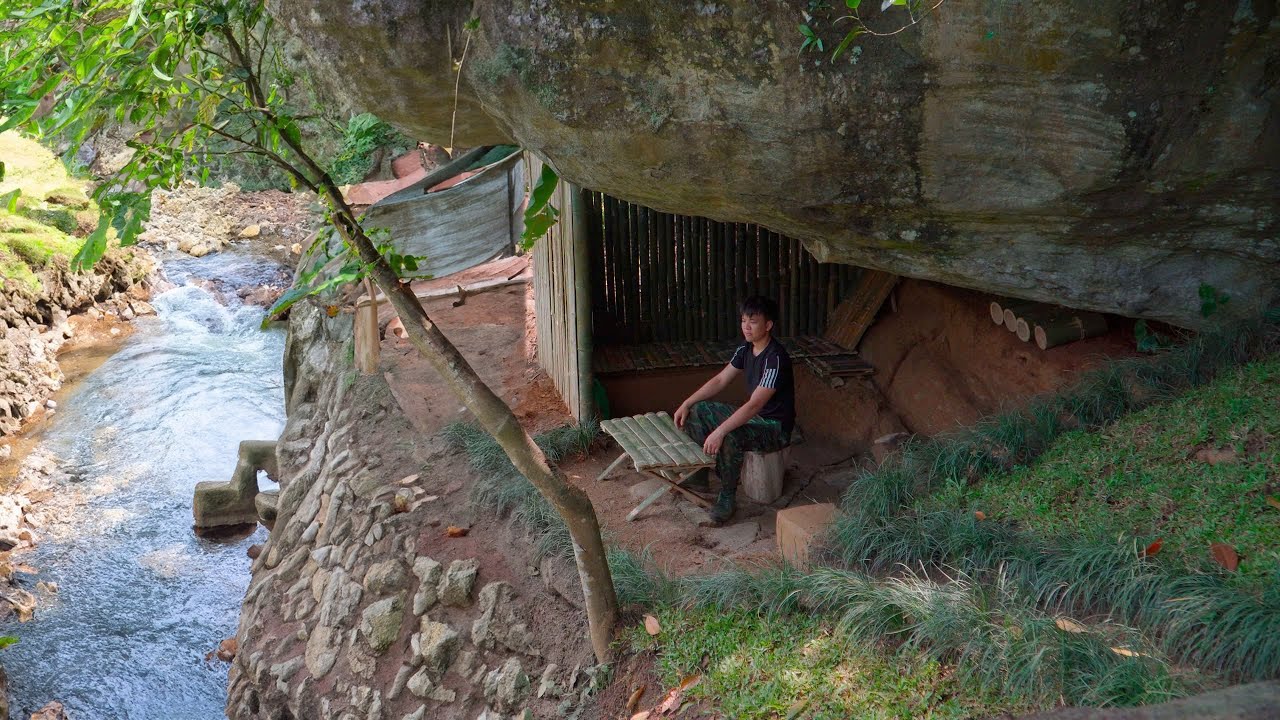 I built a warm shelter under a large rock in the rain forest and cooked ...