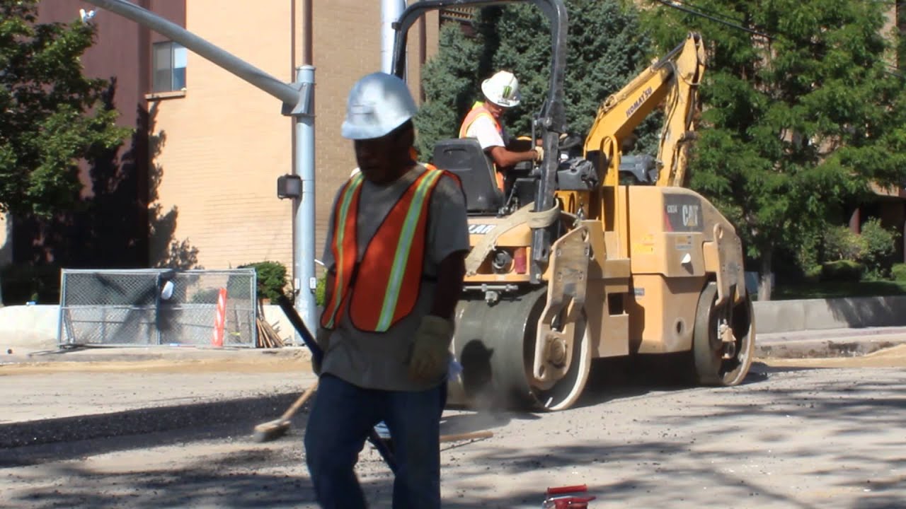 CAT CB34 roller flattening asphalt on a road construction site - YouTube