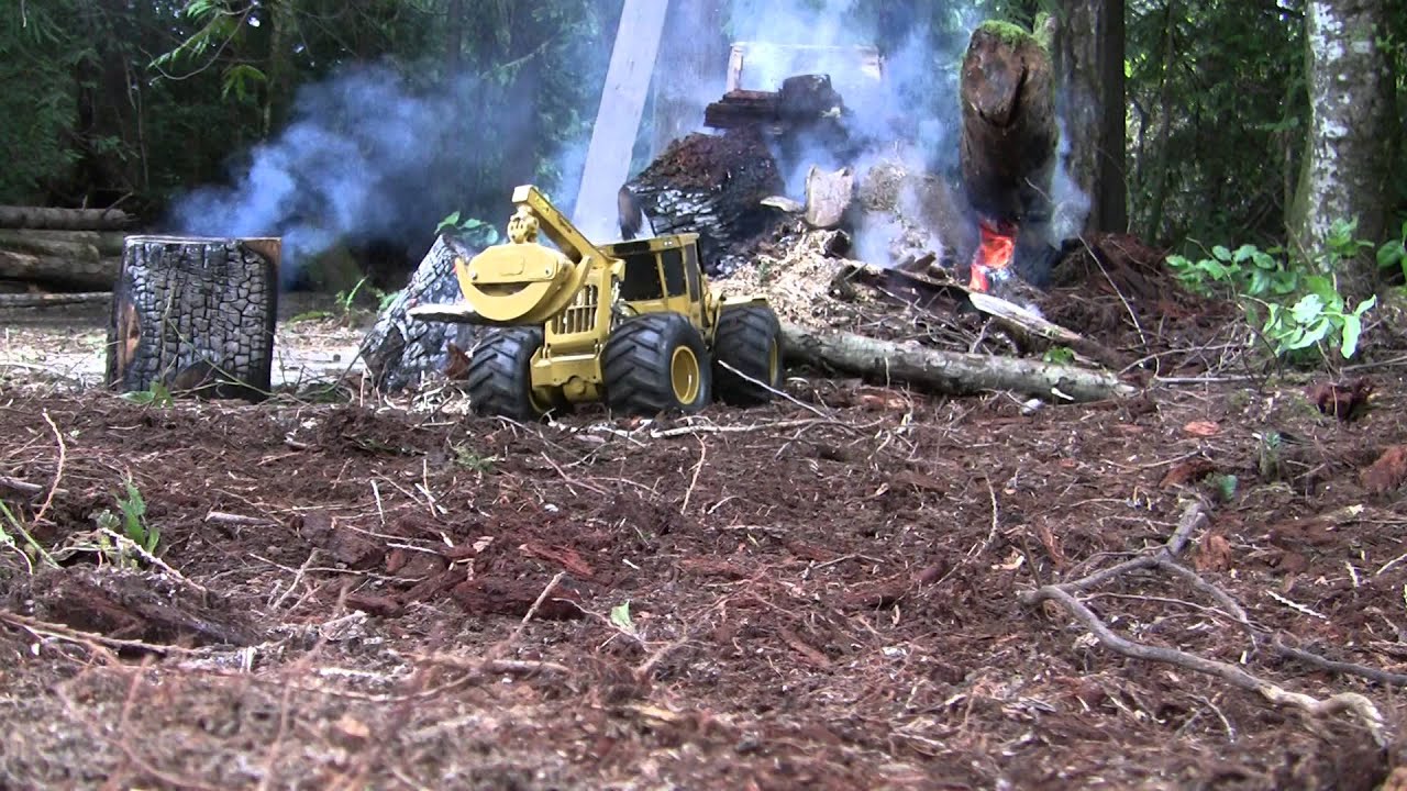 Yarding logs and stoking the fire with the Tigercat Skidder - YouTube