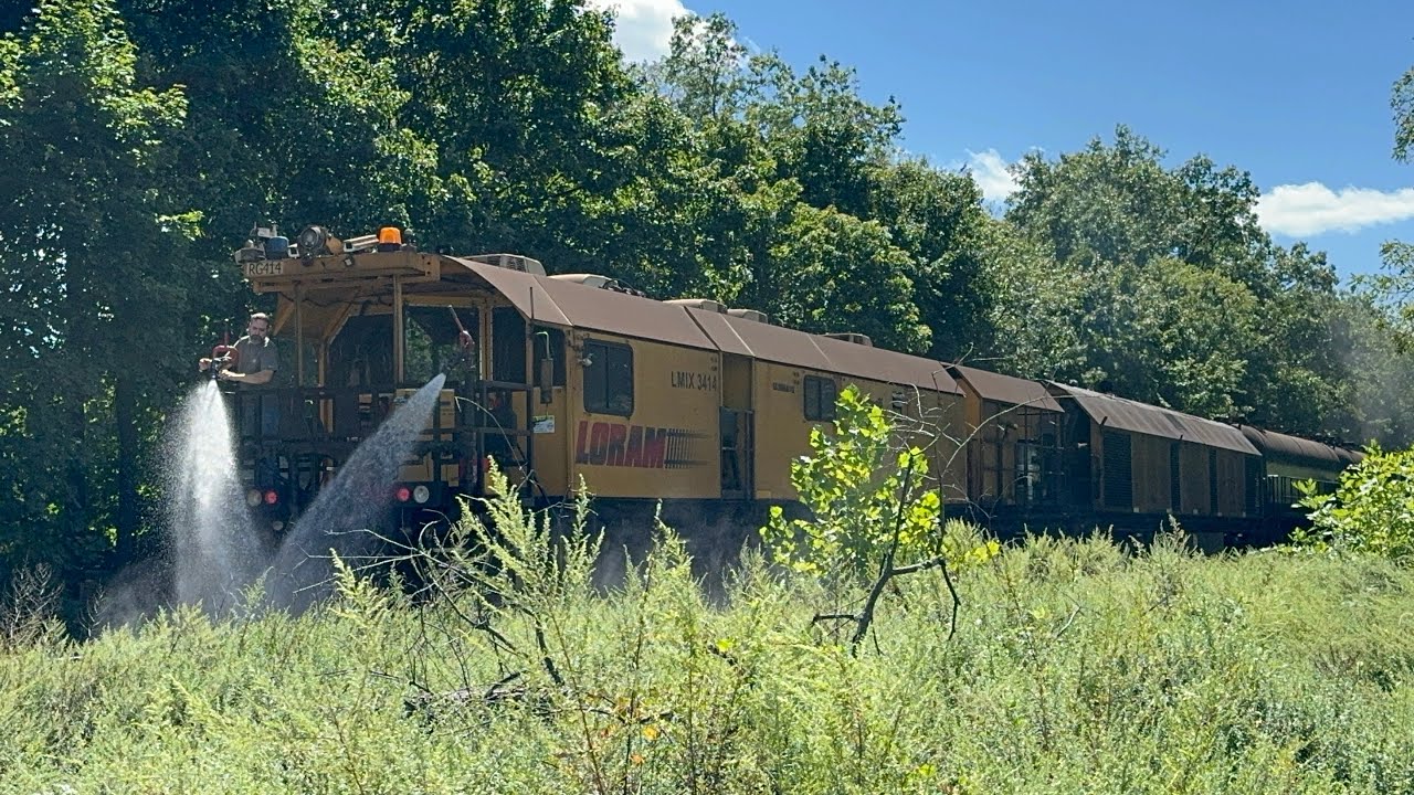 Loram rail Grinder returning east to spray water on the railroad tracks ...