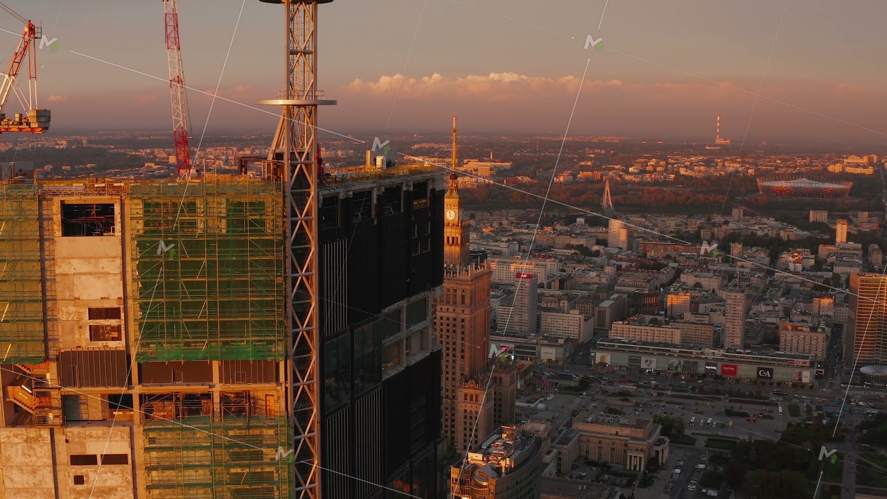 Fly around top of high rise building construction site. revealing ...