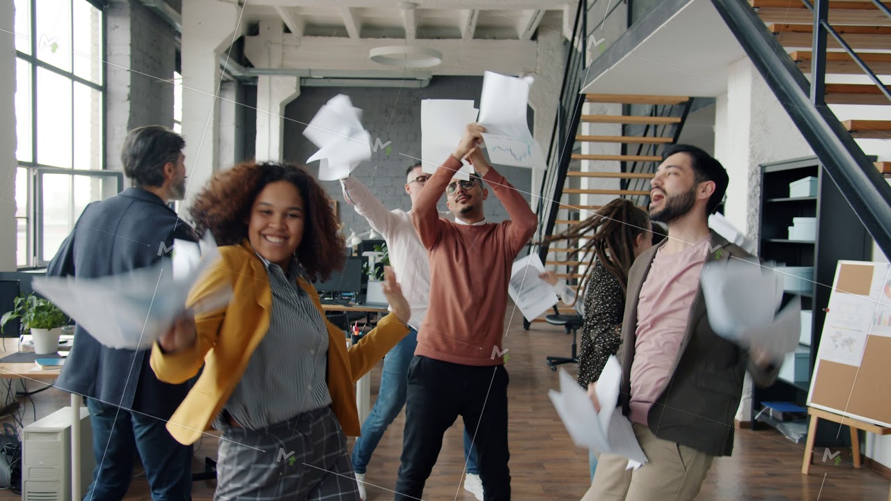 Slow motion of happy businesspeople dancing in office throwing papers ...