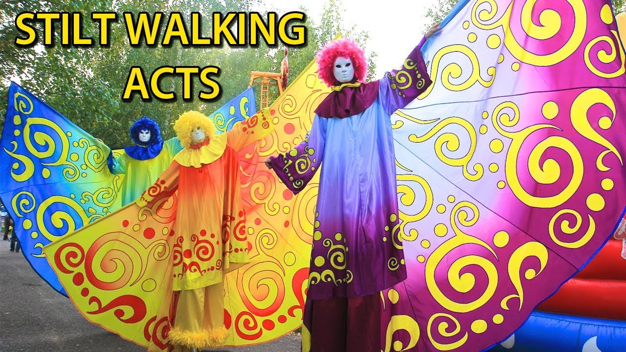 Stilts "roaming the show" on the streets. stilt-walkers on the streets ...