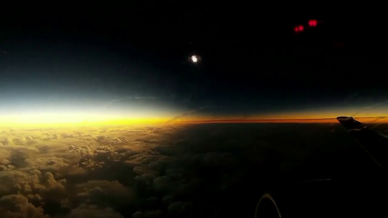 Solar eclipse seen from an airplane - YouTube