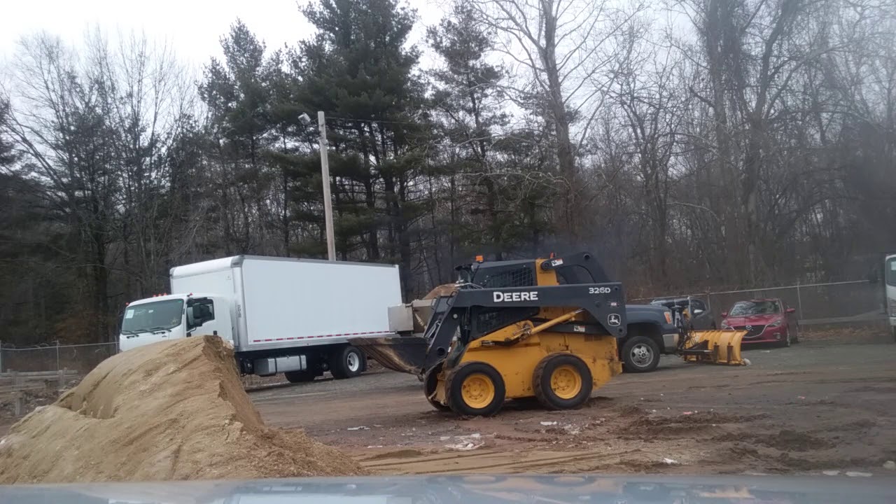 Filling my GMC 3500 HD sander with the John Deere 326D skidsteer - YouTube