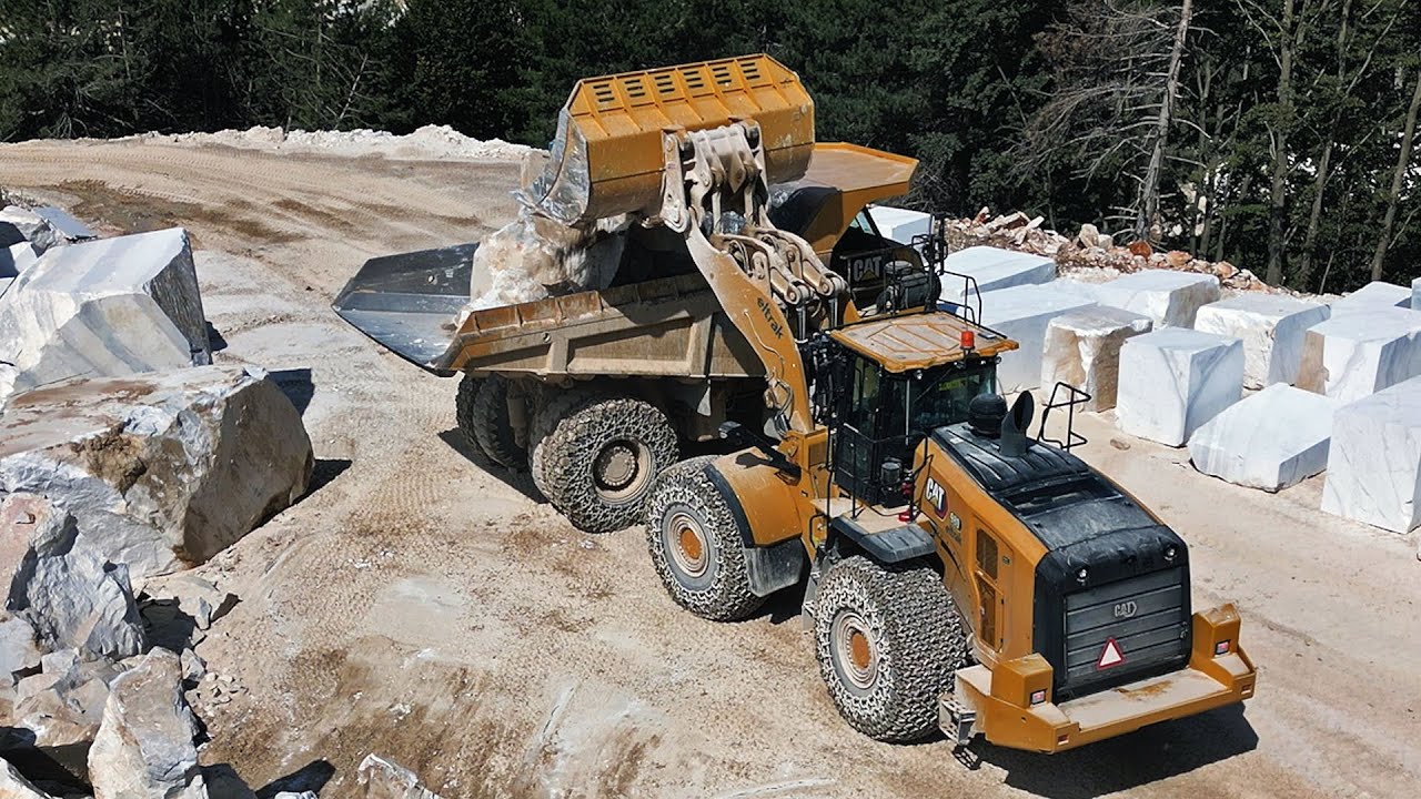 CAT 980 wheel loader loading CAT 770 dump truck in marble quarry. - YouTube