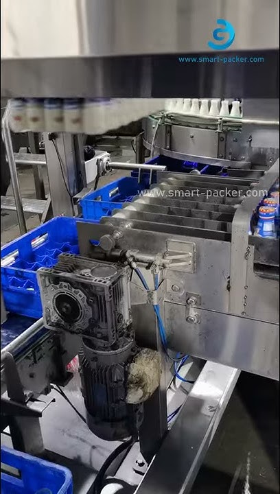 Automatic milk glass bottle neck sleeve inserting shirnking labeling machine with robot hands ...