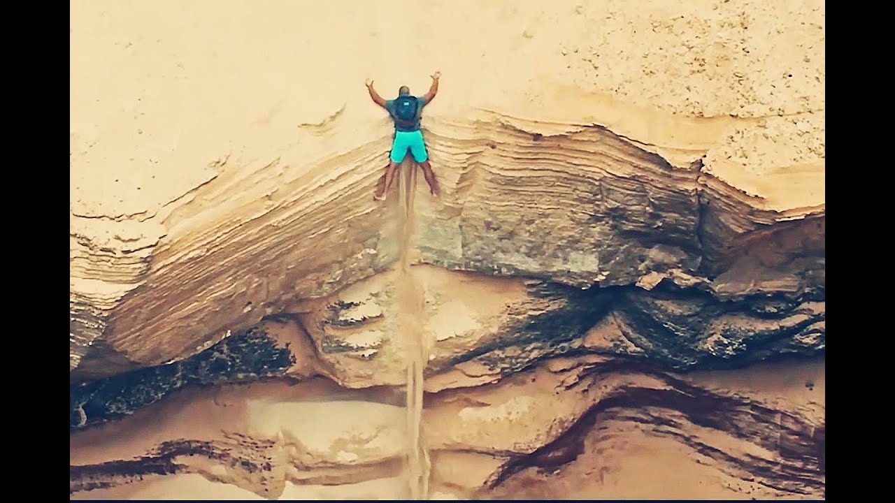 A Man Falls by a Cliff on a Desert Beach and Suffers Serious Injure ...