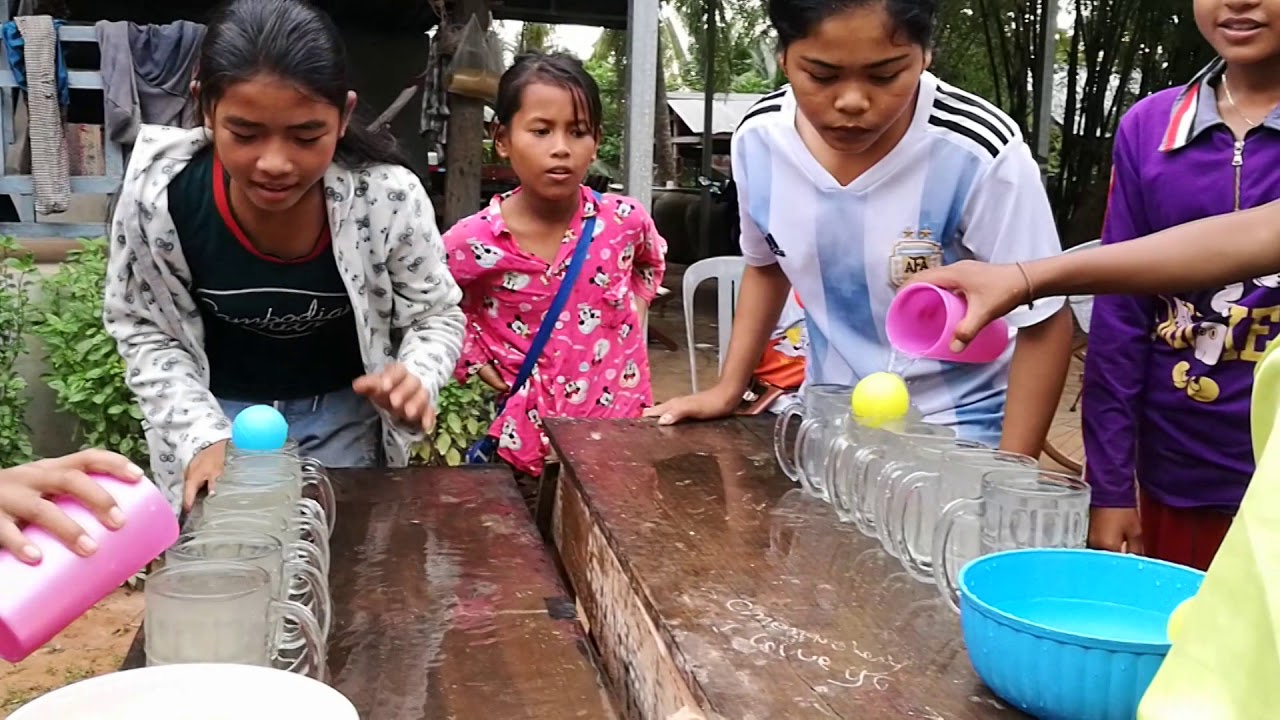 Blowing small ball across glass of full water - YouTube