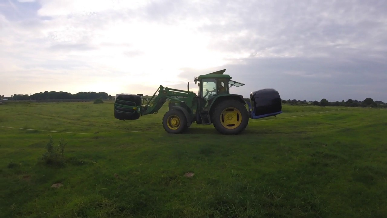Stacking silage bales - YouTube
