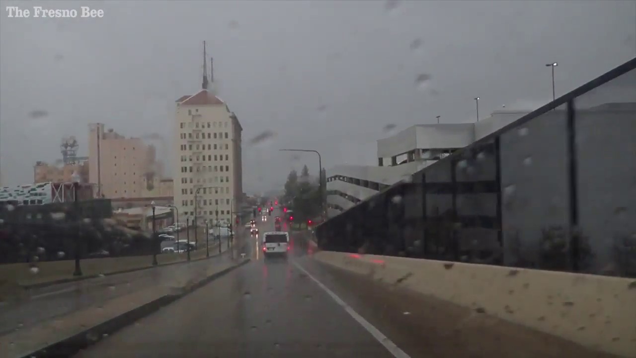 Blowing rain briefly whips downtown Fresno Friday - YouTube