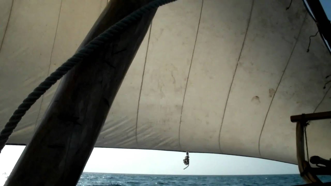 Putting up the sail on the dhow - YouTube