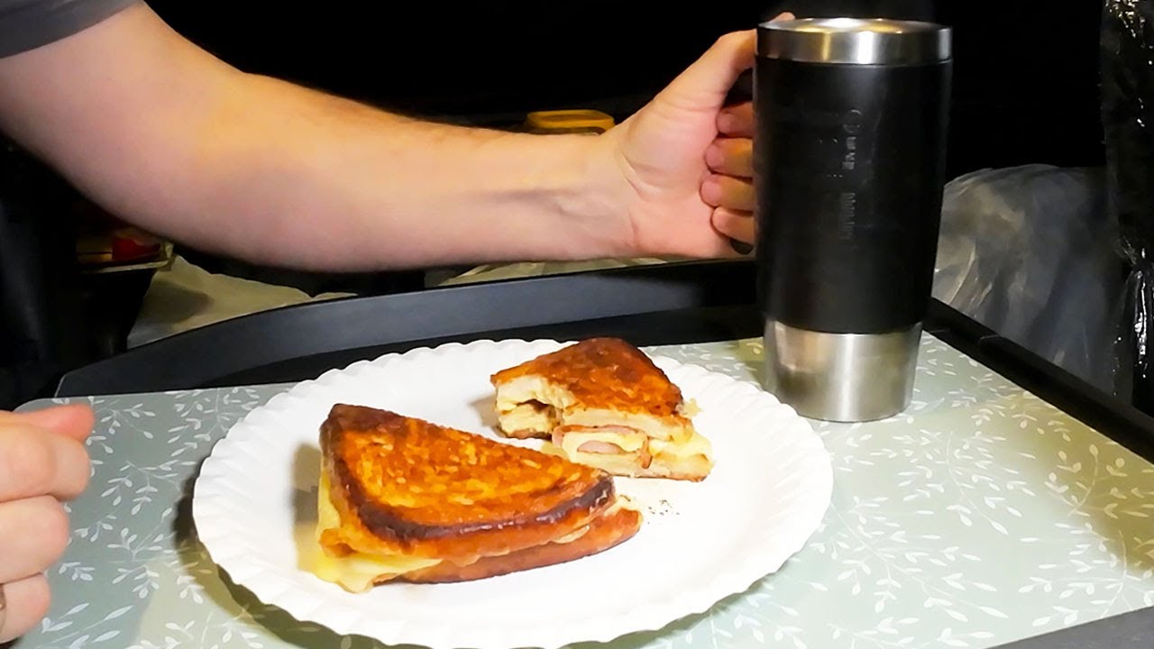 Truck driver cooking inside truck. Morning sandwich before work routine ...