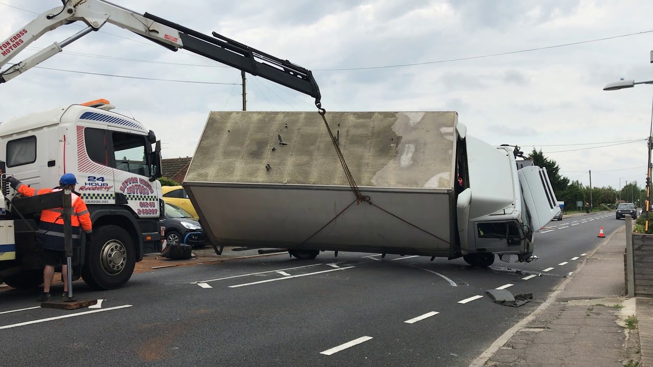Watch as overturned lorry is dragged off new car display - YouTube