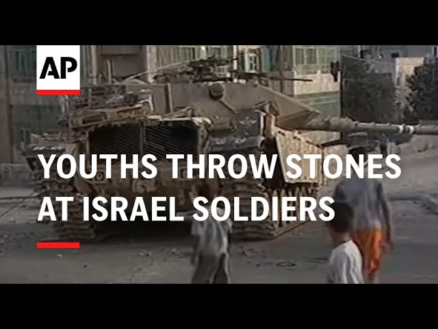 Palestinian Boy Throwing Rock At Tank