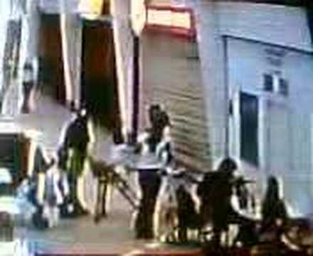 Store shutters fall on womans head - YouTube