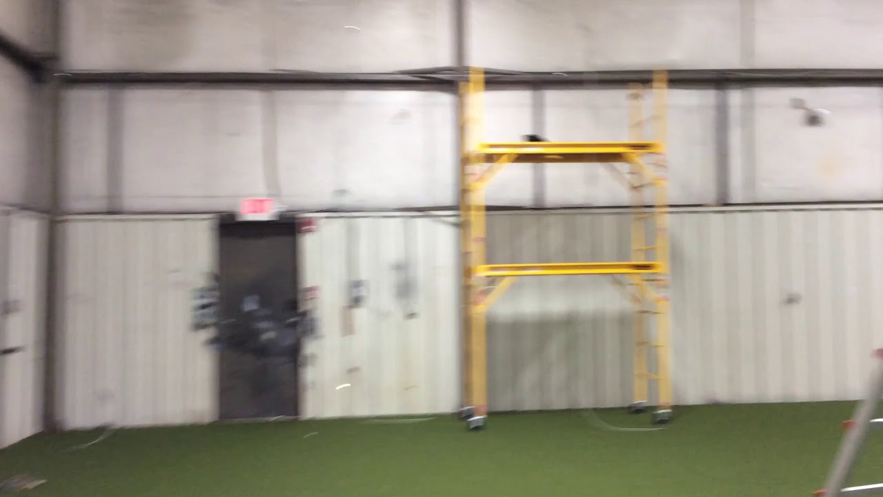 Little giant ladder using to install batting cage cable system - YouTube