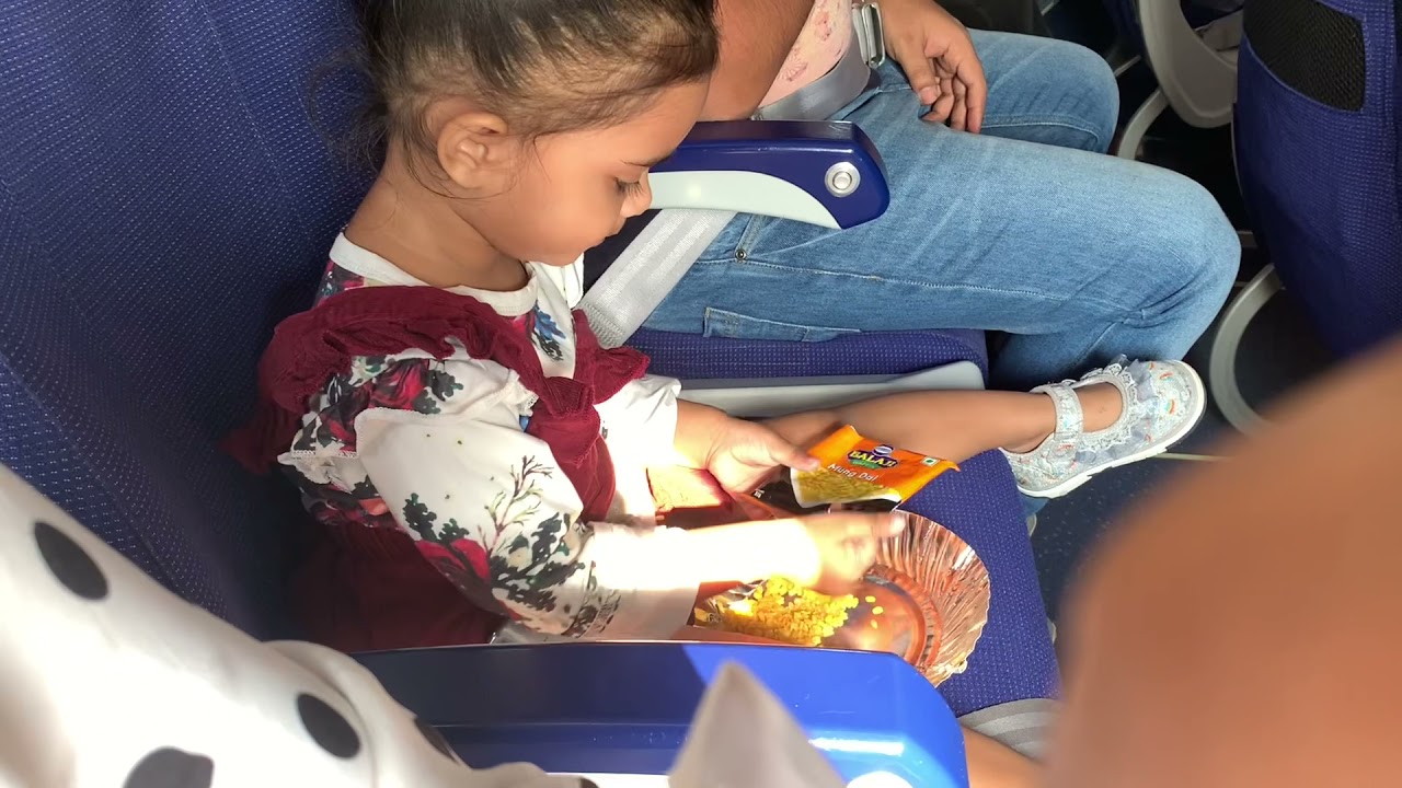 Cute little girl is enjoying in the flight | little girl is sitting ...
