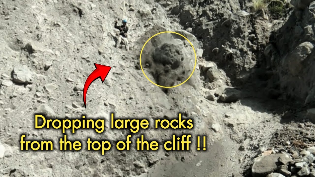 The miner climbed the cliff, knocking down large rocks and black sand ...