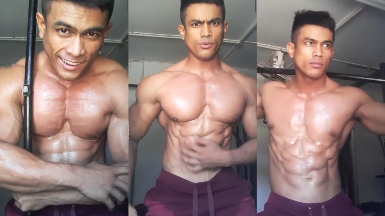 Malaysian bodybuilder exercising at home, sweating and showing off his ...