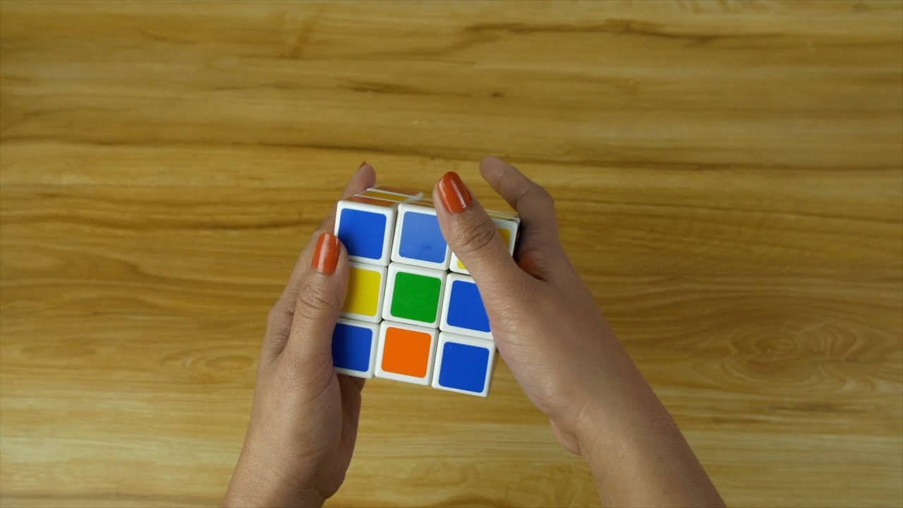 Closeup shot of a woman hands playing with Rubik's cube during ...