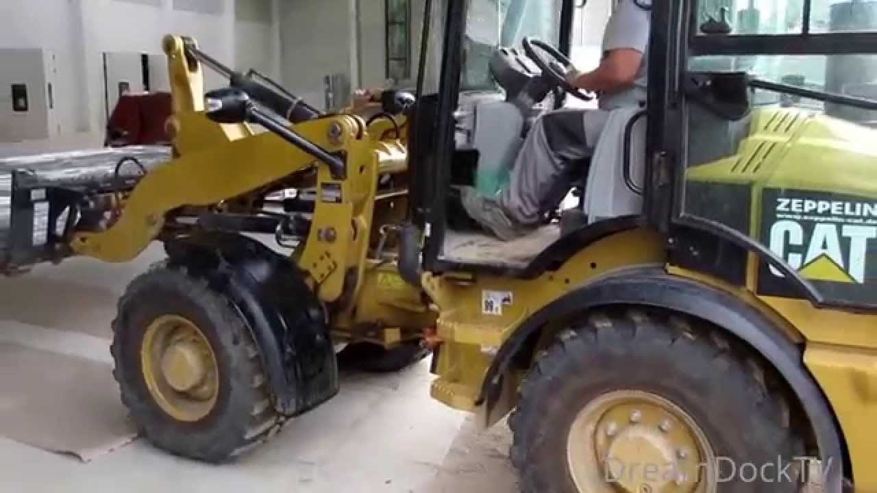 WHEEL LOADER CATERPILLAR 907H WORKING ON CONSTRUCTION SITE WITH BUCKET ...