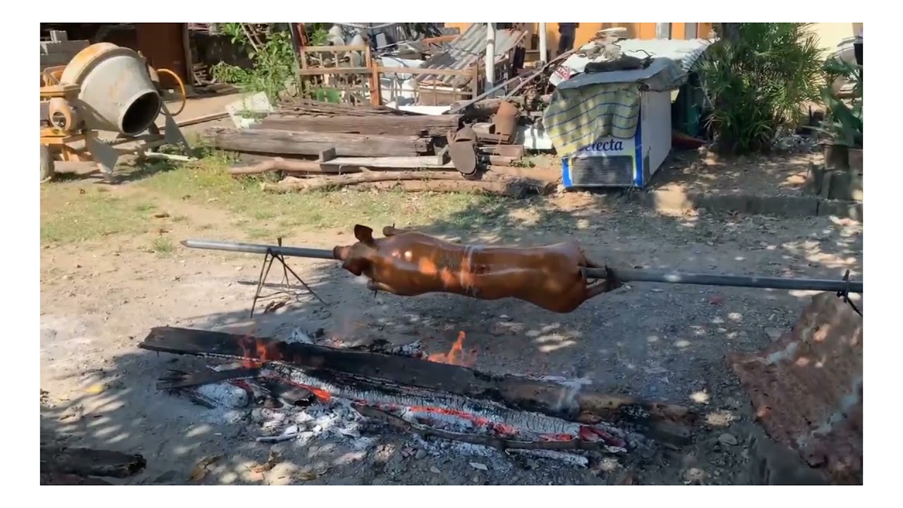 Roasting pig over fire (lechonnn ) - YouTube