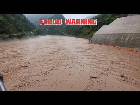 Massive volume of sediments released as the dam spillway gate opens before the storm