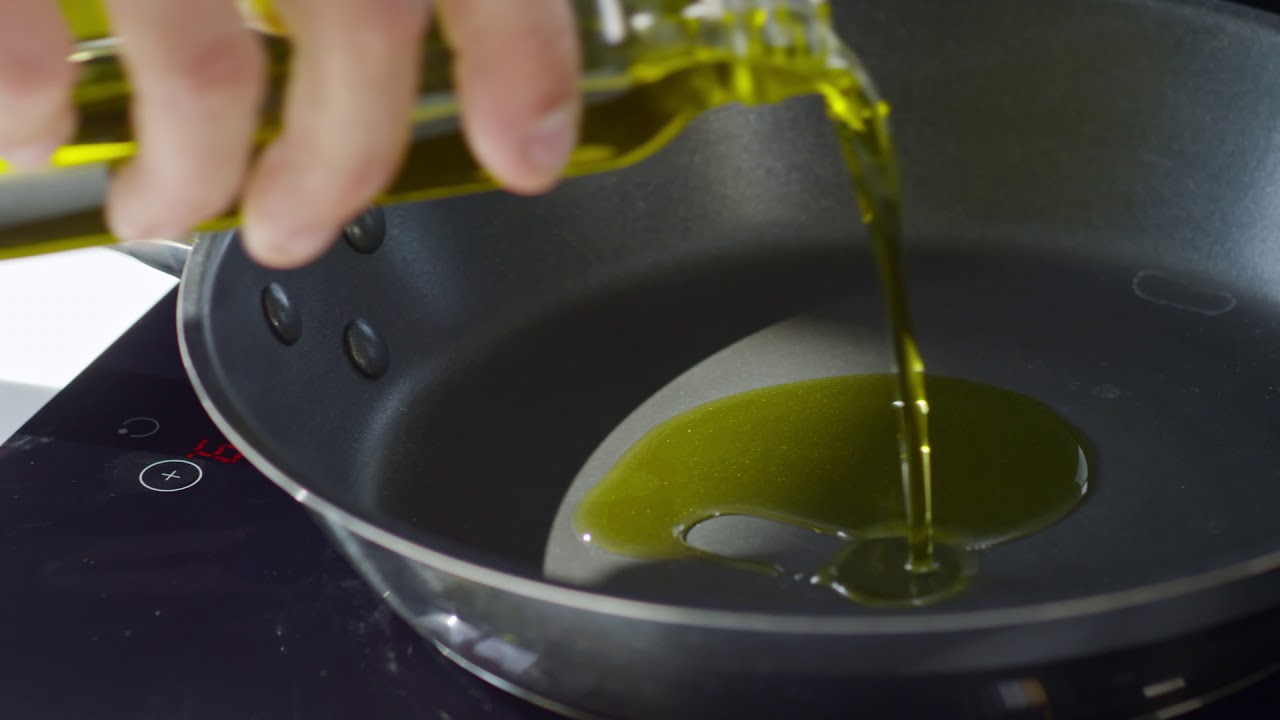 videoblocks close up of hands of male cook pouring olive oil into pan ...