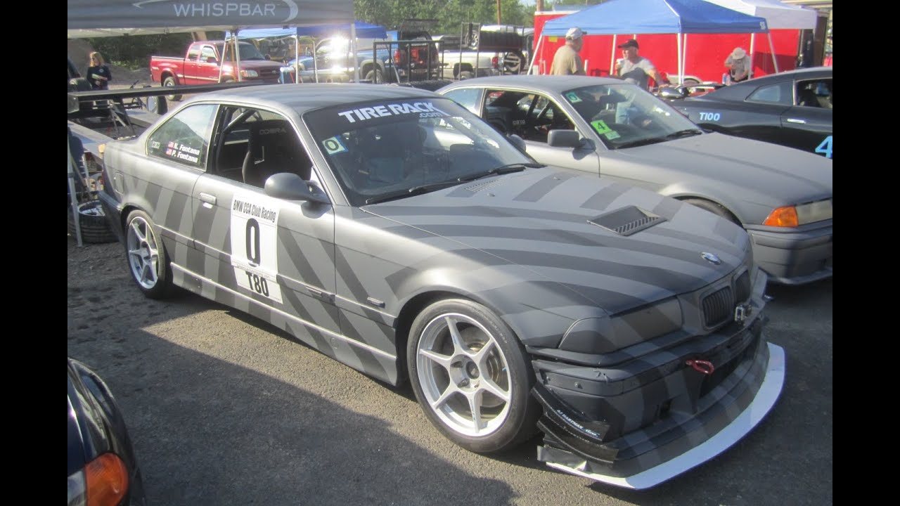 pointing by the battleship gray BMW E36 at Palmer Motorsports Park ...