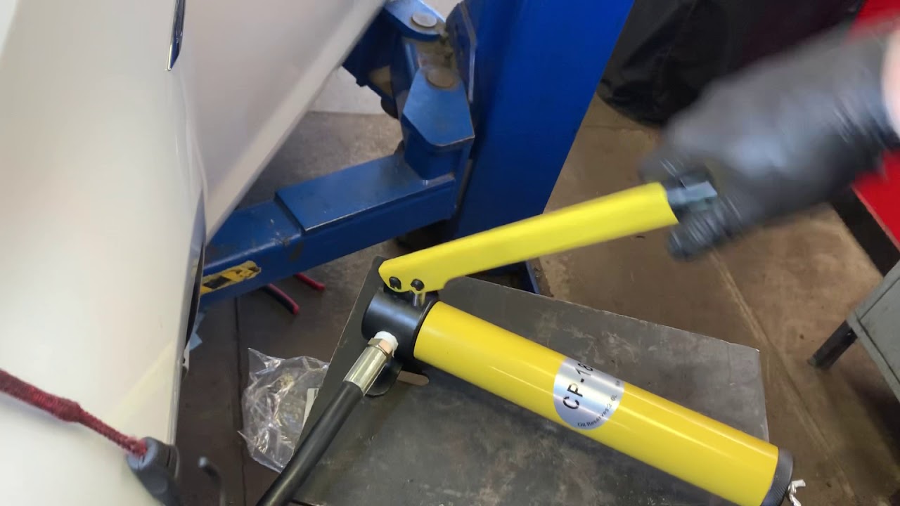 Using a die-punch steel cutter to cut a bigger strut tower hole on a ...
