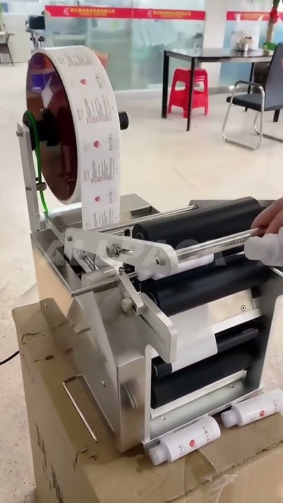 How semi-automatic labeling machine works on round bottle? - YouTube