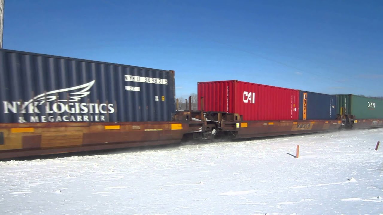 CN 2505 C44-9WL blows by with an intermodal container train near ...