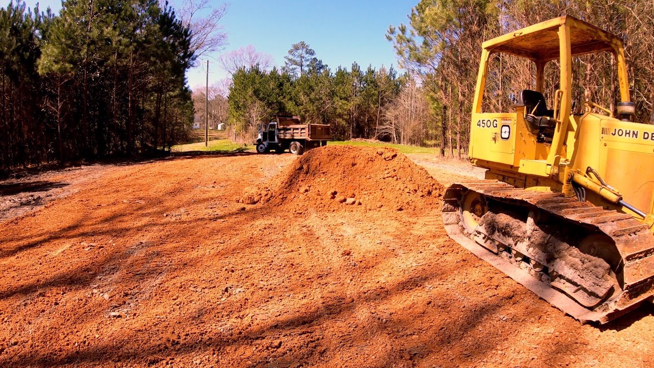 John Deere 450G Hay Barn Pad and Hillside Grading - YouTube