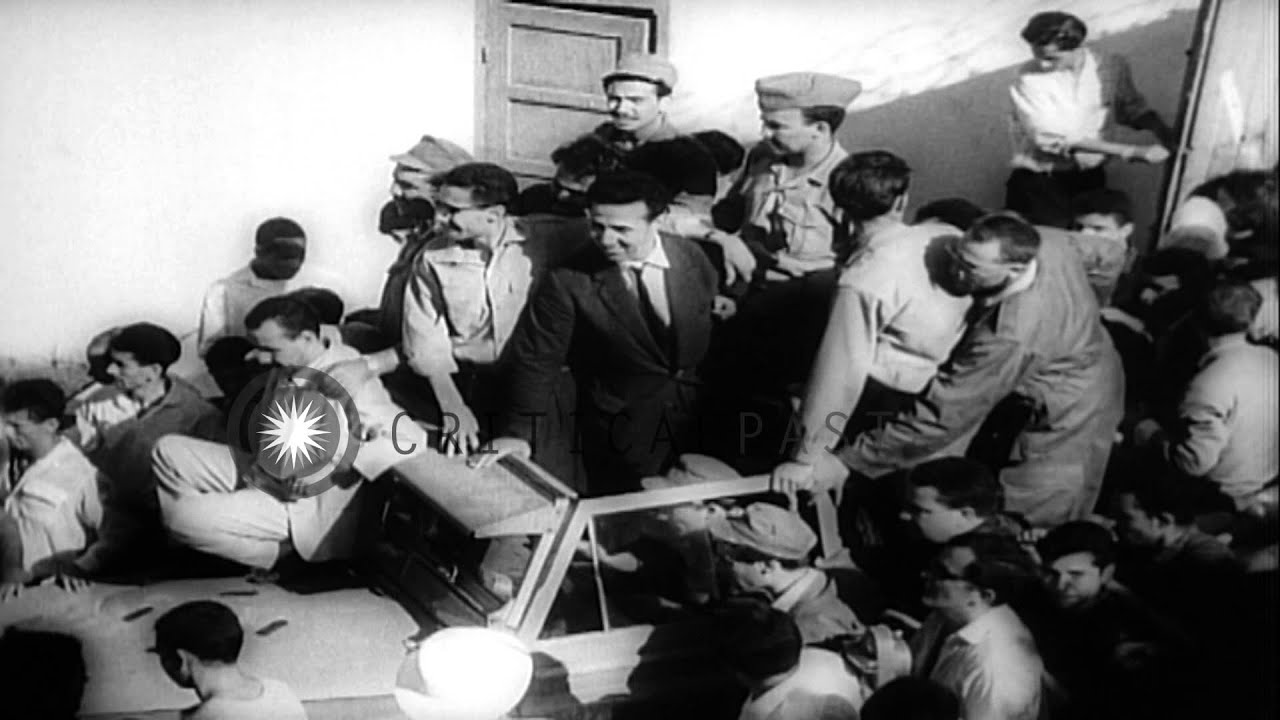 Colonel Houari Boumedienne greets people and addresses a public meeting ...